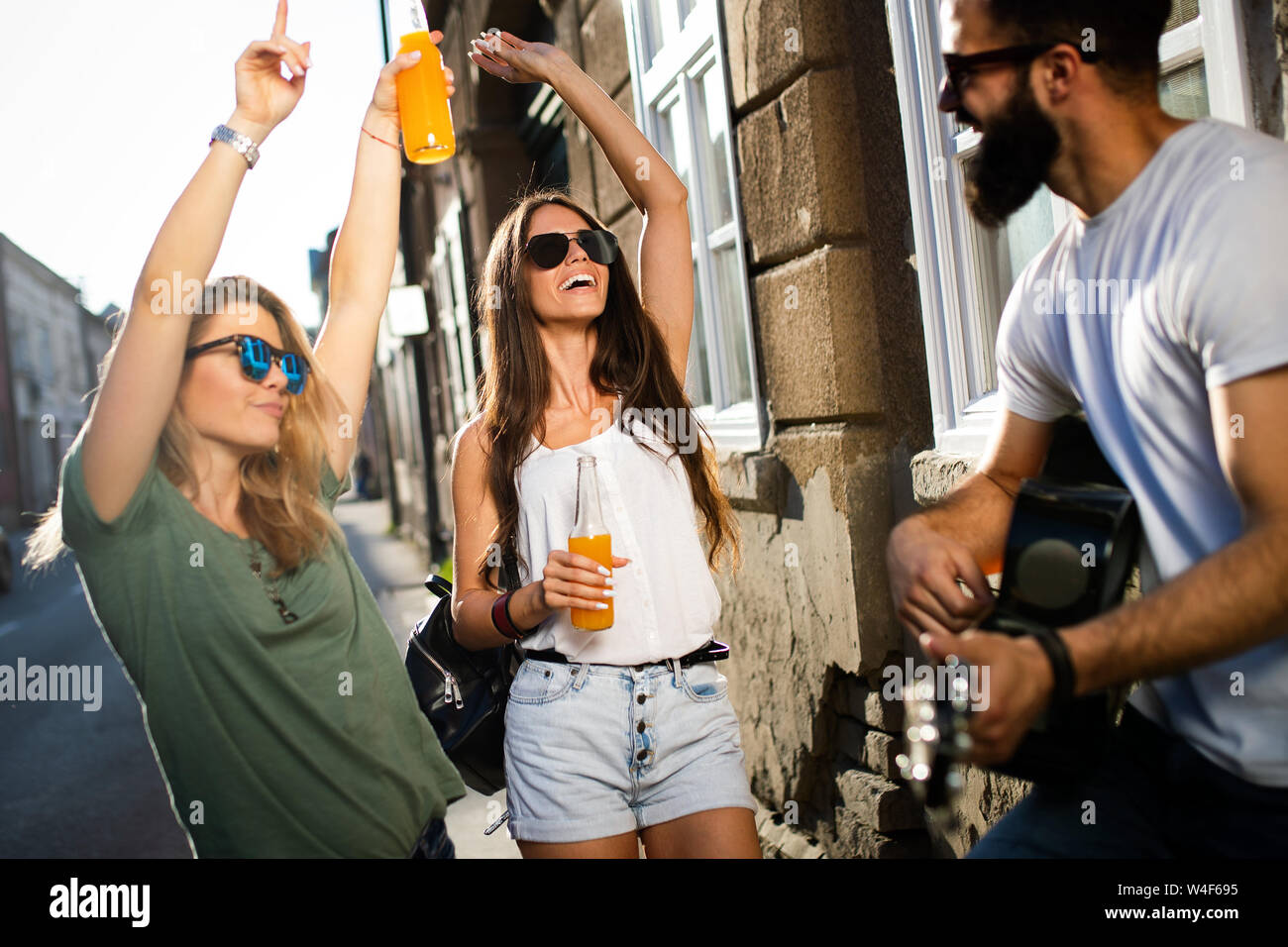 Happy young people having fun spending good time together Stock Photo ...