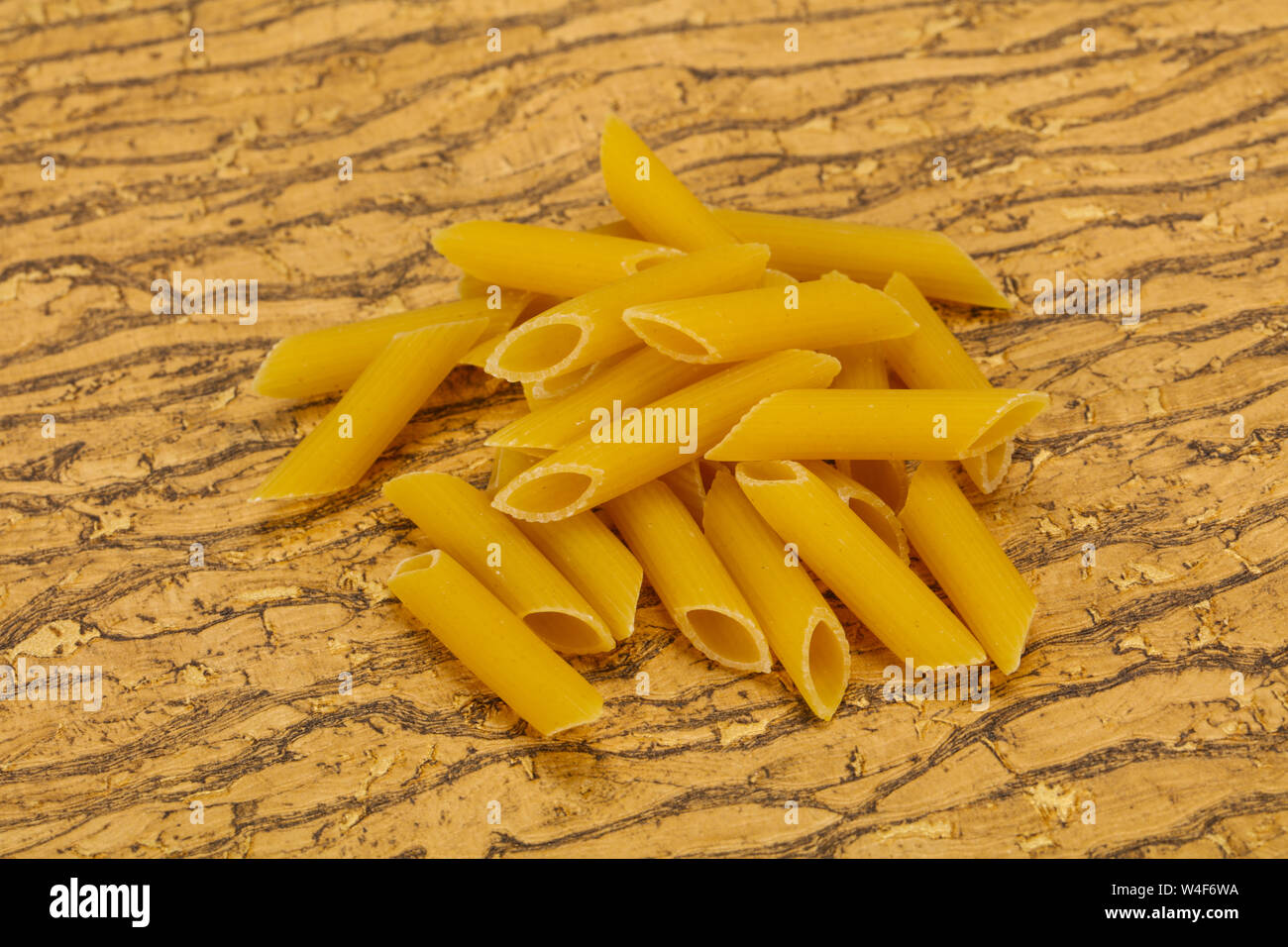 Raw penne pasta ready for bowl Stock Photo - Alamy