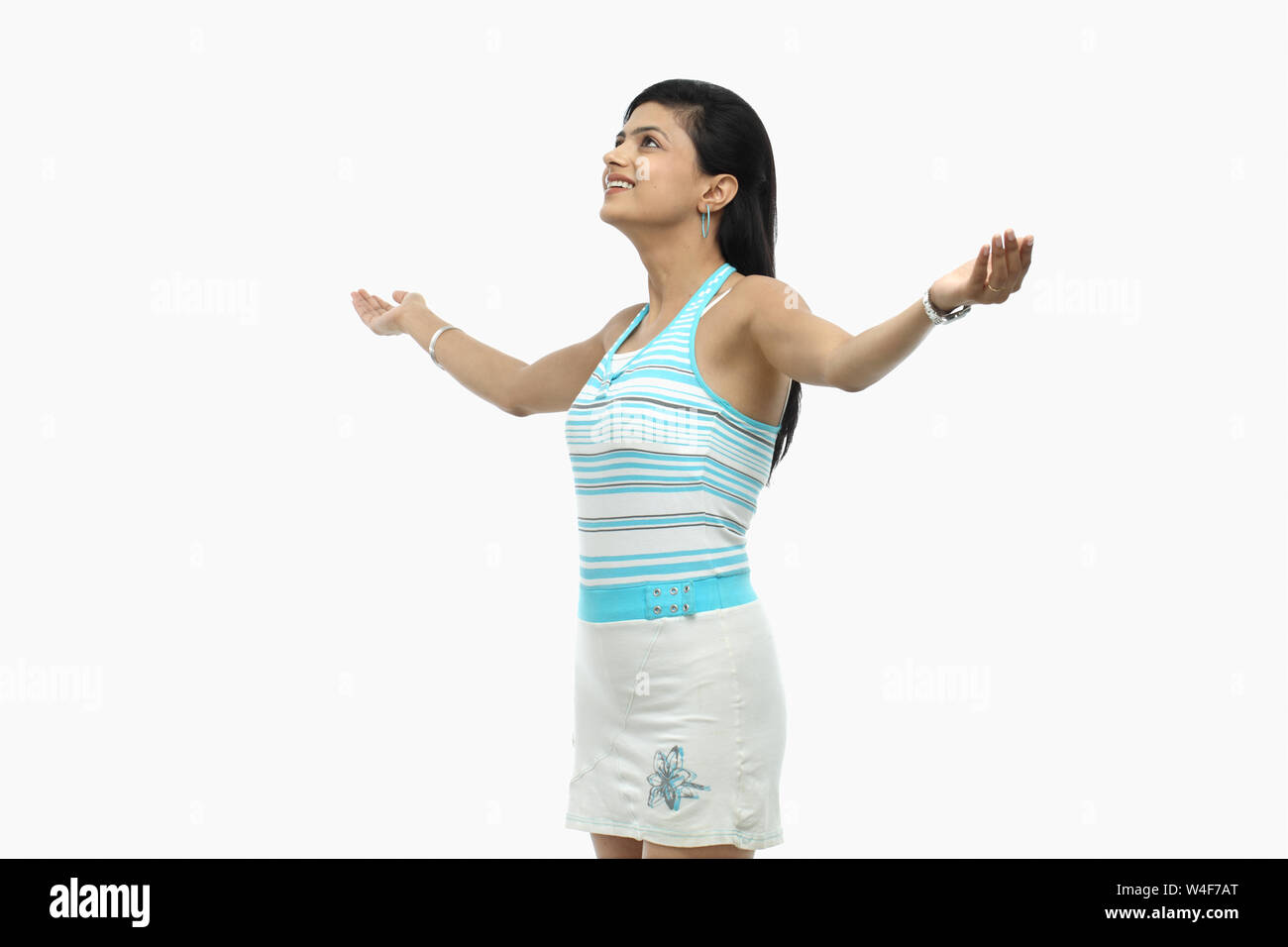 Woman standing with her arm outstretched Stock Photo - Alamy