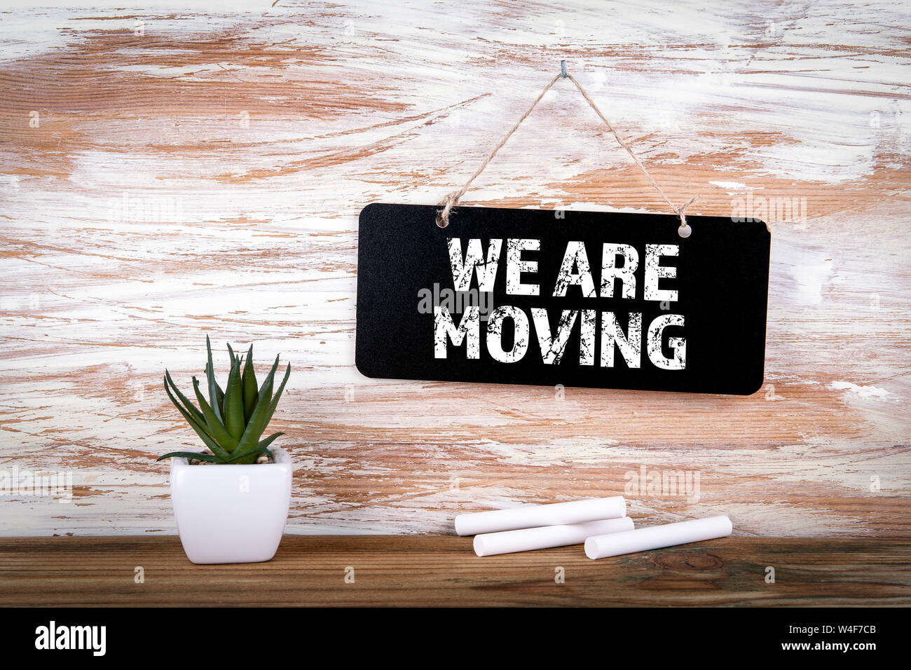 We Are Moving. Small blackboard on the wall with text Stock Photo - Alamy