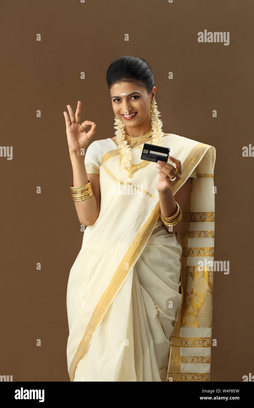 South Indian woman showing Ok sign with credit card Stock Photo - Alamy