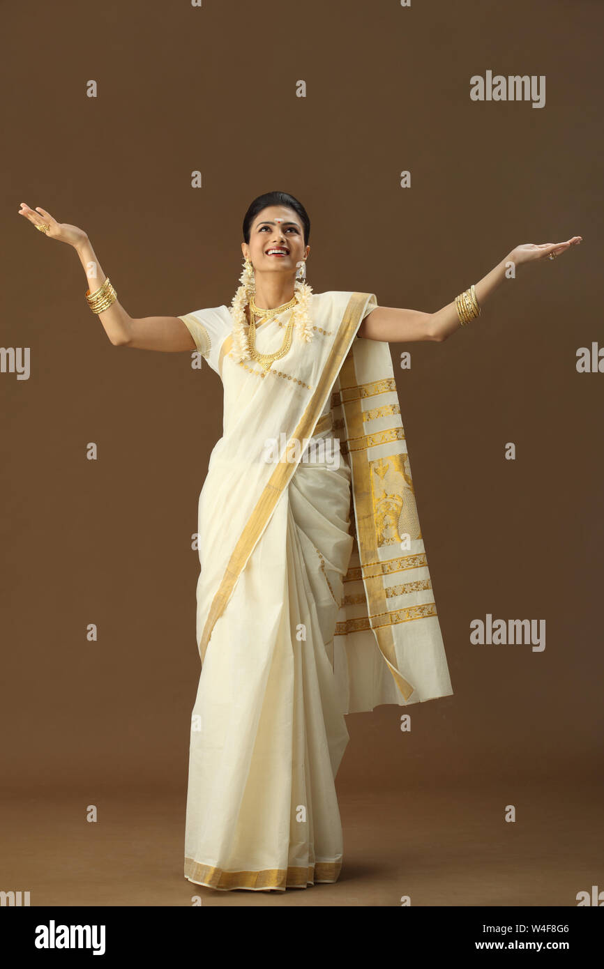 South Indian woman standing with her arm outstretched Stock Photo - Alamy