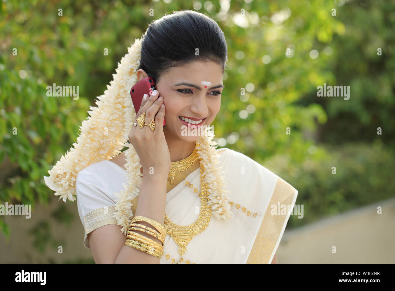 South Indian woman talking on mobile phone Stock Photo - Alamy