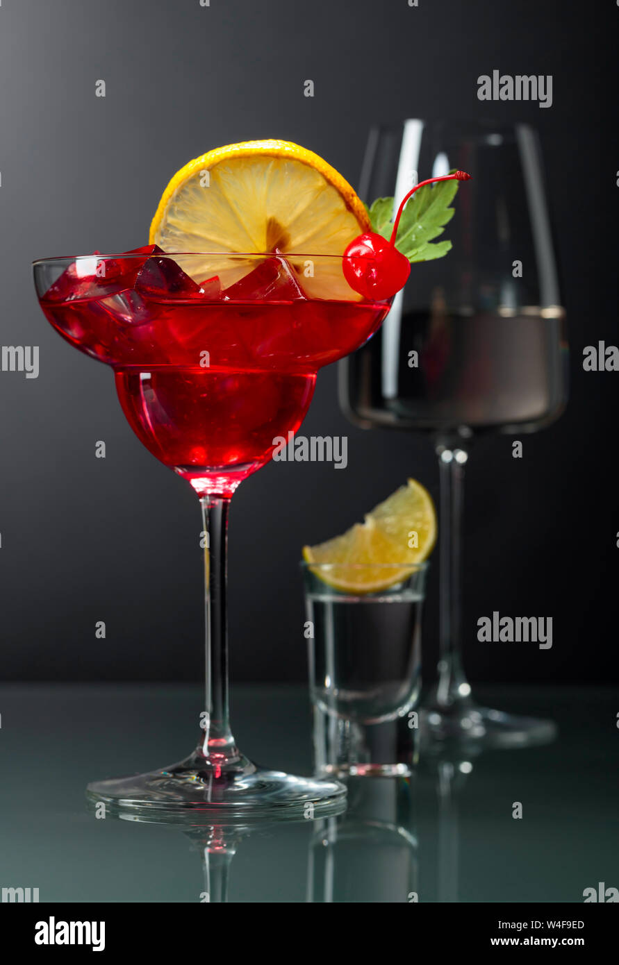 Various alcoholic drinks on a black background. Focus on foreground ...