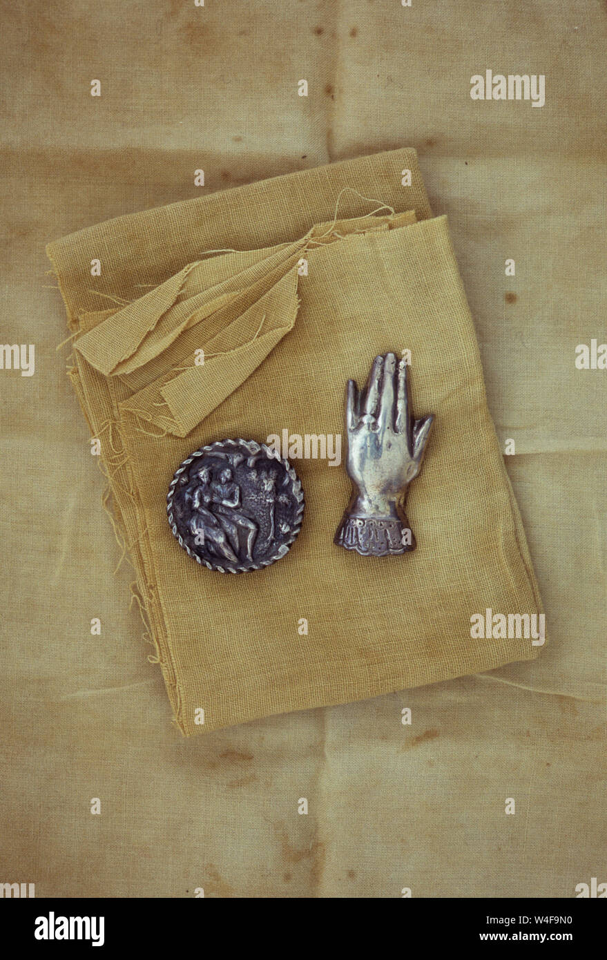 Small antique silver hand and silver token showing lovers on bench laid ...