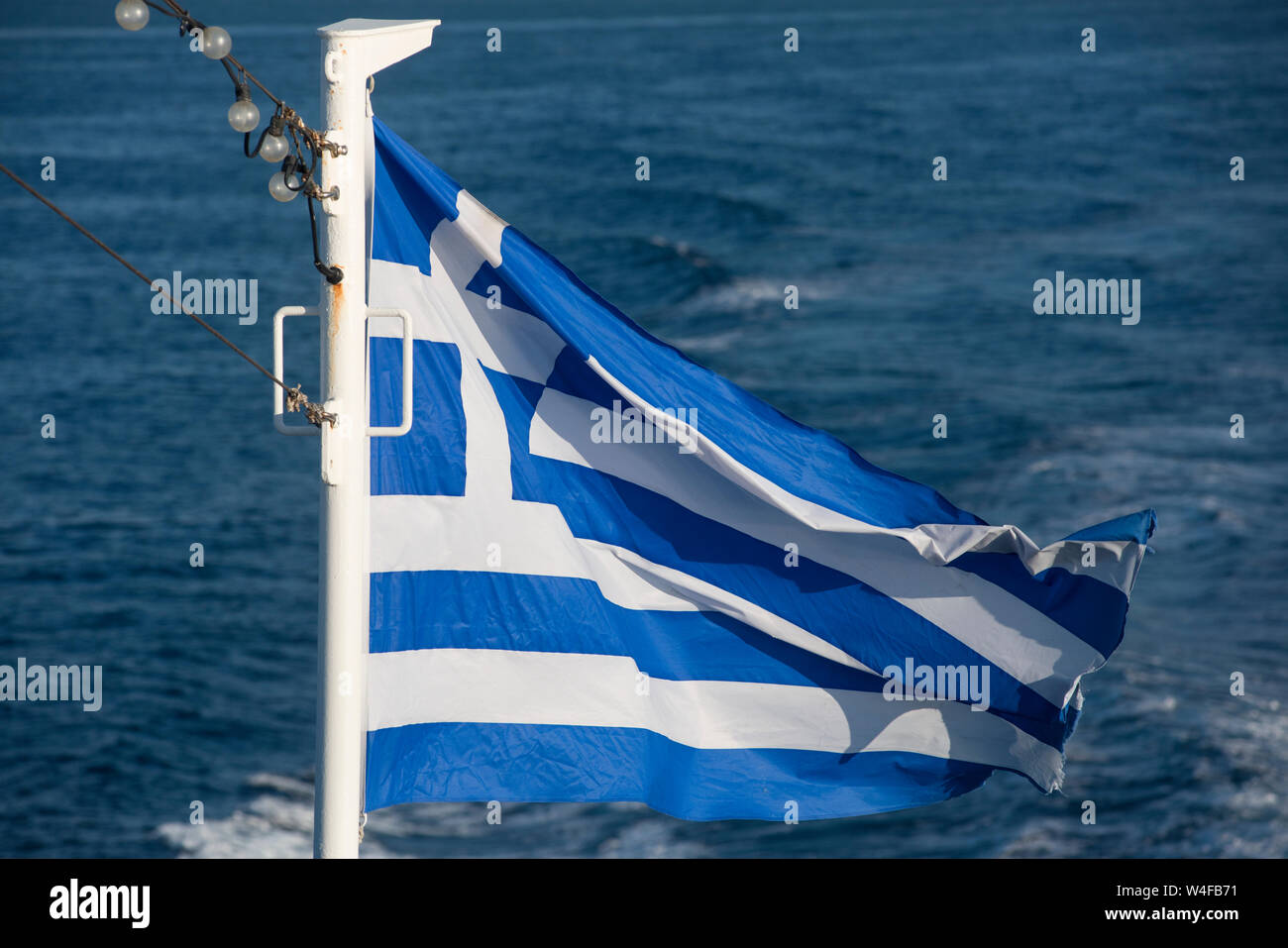 Greek flag waving in the sky. Sea background Stock Photo - Alamy