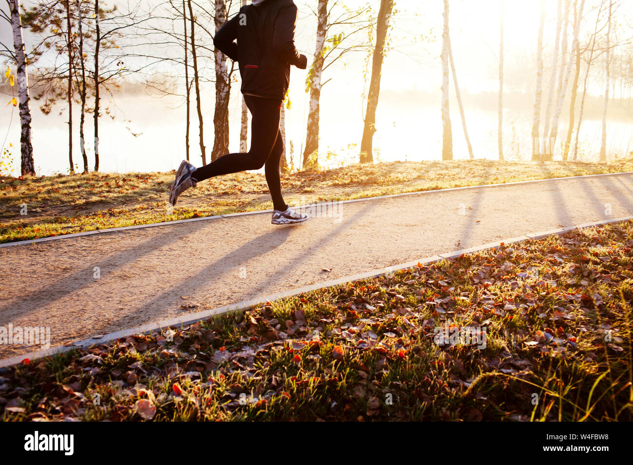 Man running at autumn during sunrise Stock Photo - Alamy