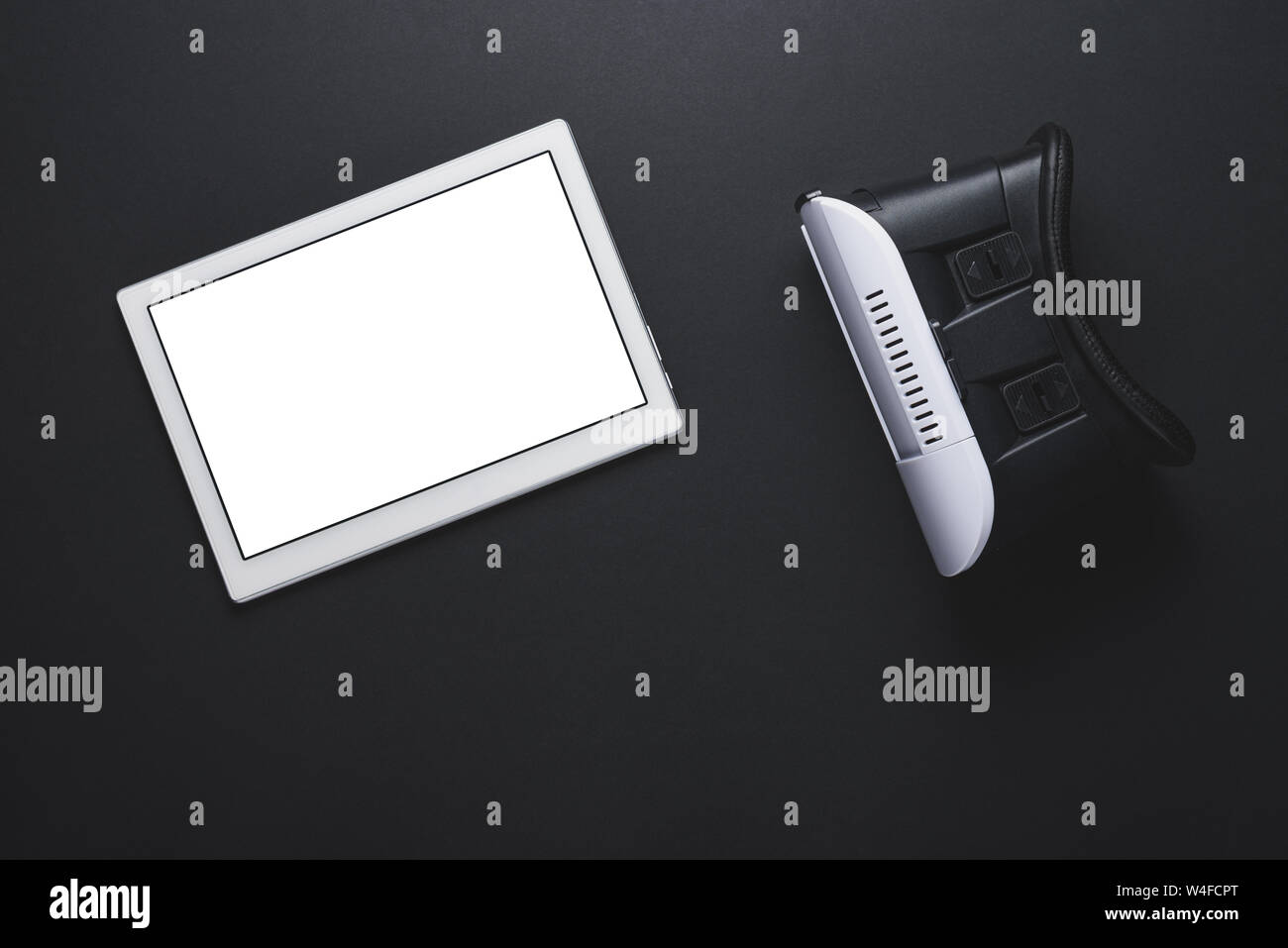 Tablet with white screen for mock up and VR glasses on black background ...