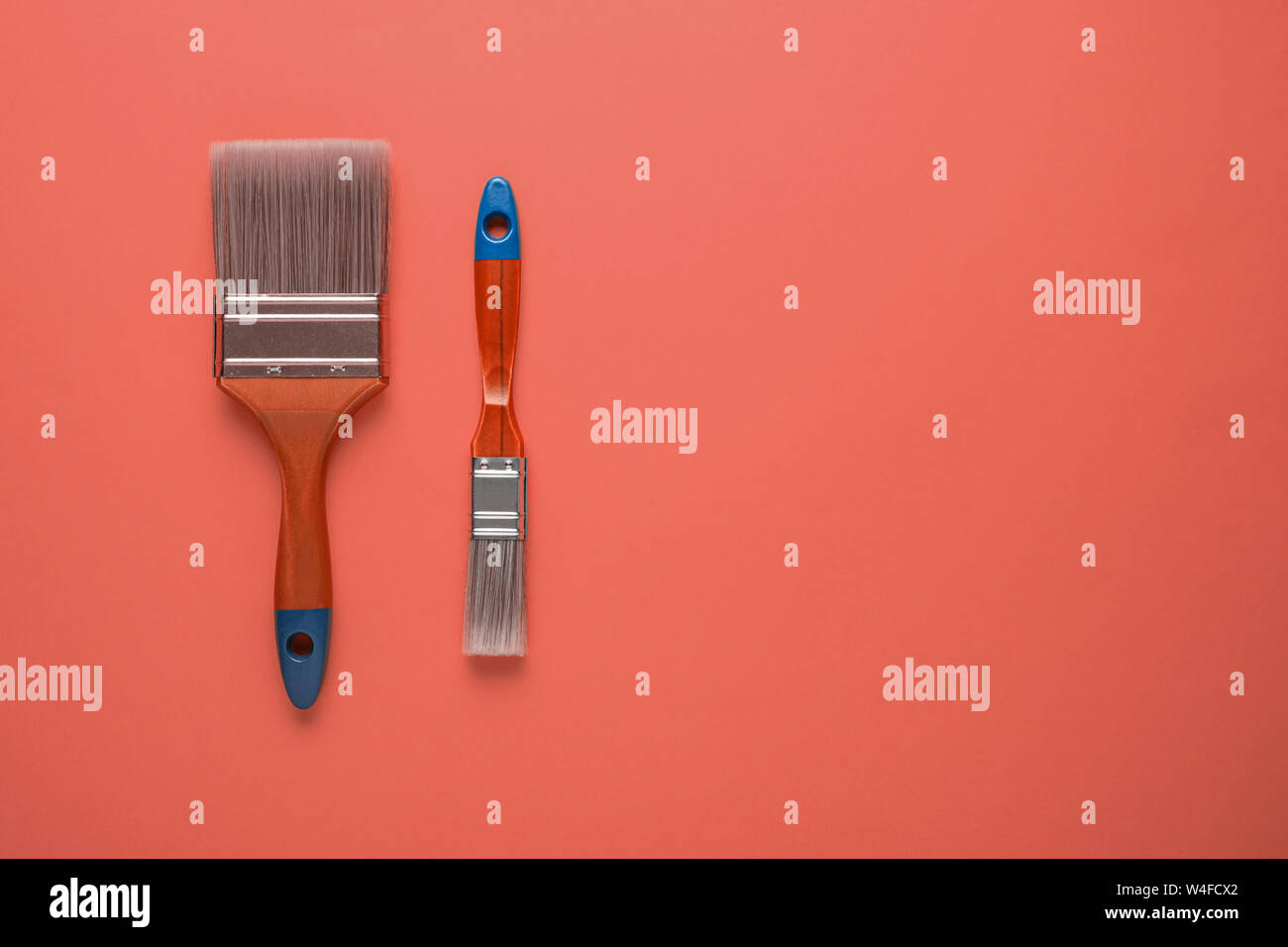 Two painting brushes of large and small size on a fashionable ...