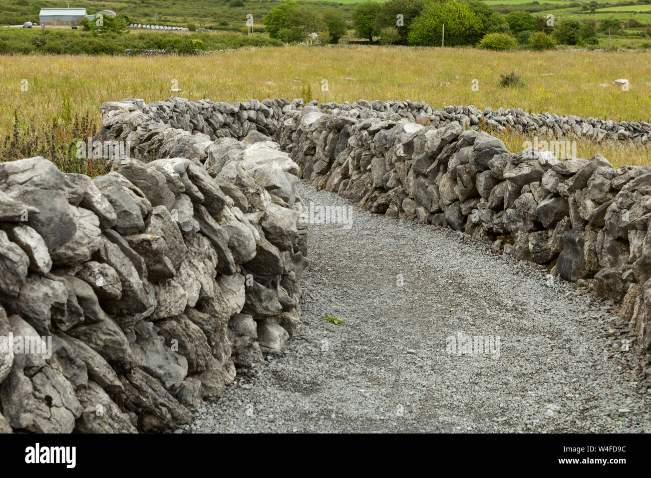 pathway between two stone walls Stock Photo - Alamy