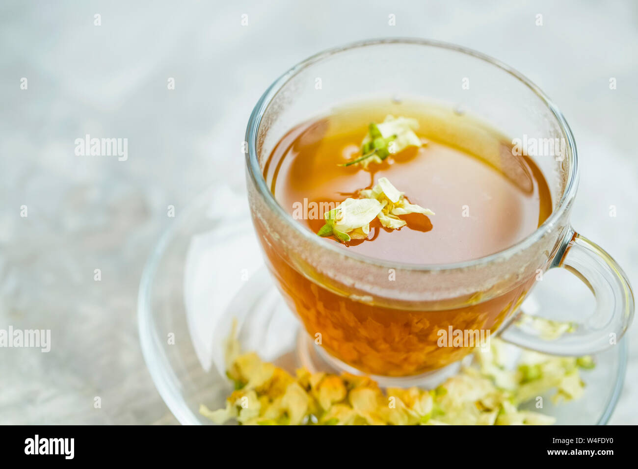 Jasmine tea in transparent cup with jasmine flowers, healthy herbal ...