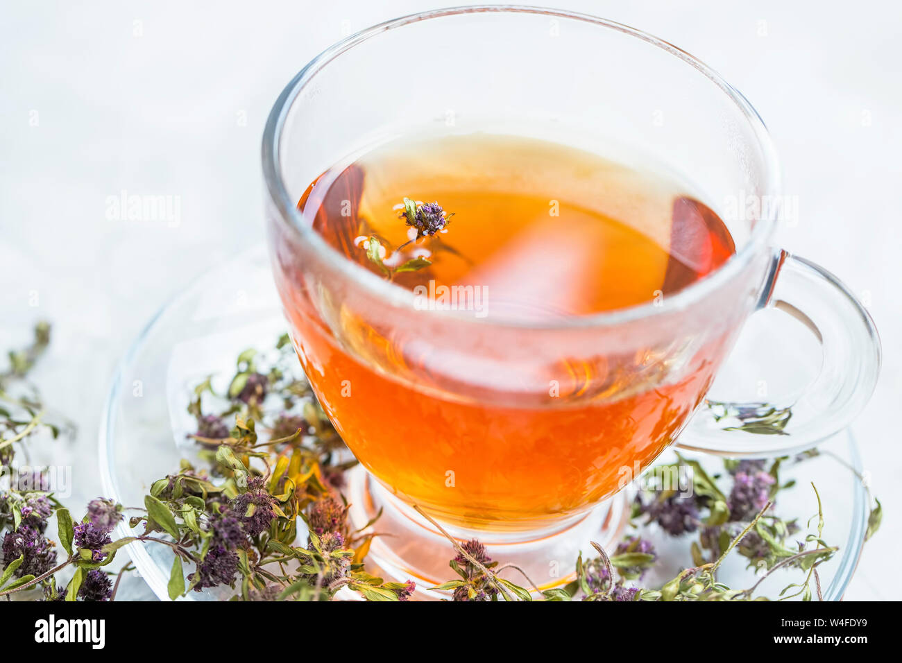 Thyme tea in transparent cup with thyme flowers, healthy herbal natural ...