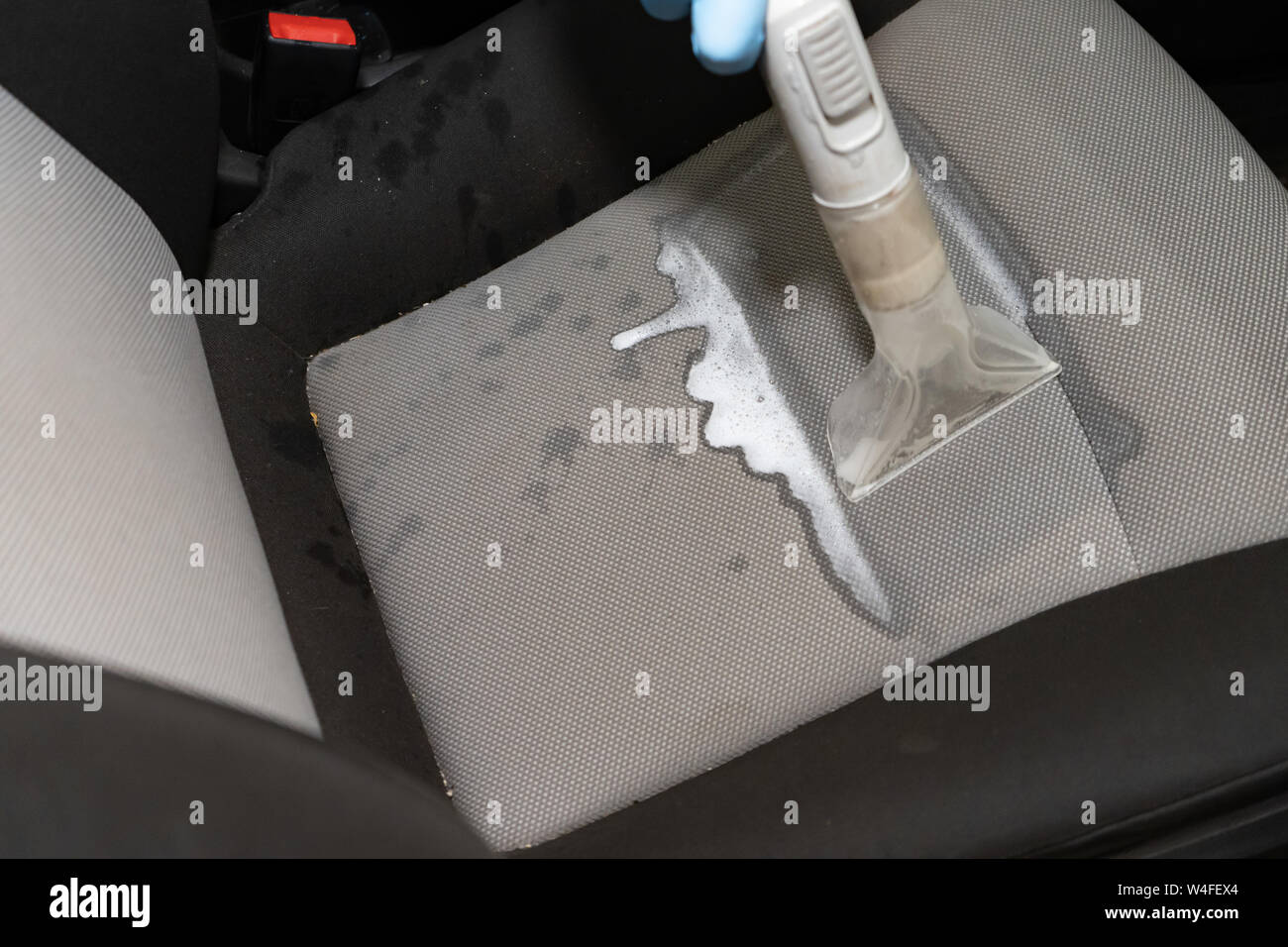 Dry cleaning salon cars. Worker uses washing vacuum in the car Stock ...