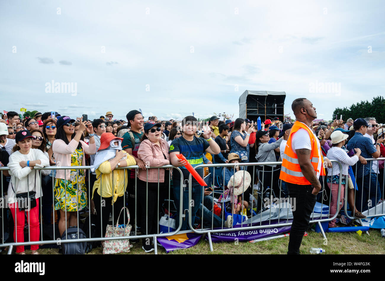 The audience at 2019 Barrio Fiesta in London behind metal barriers ...