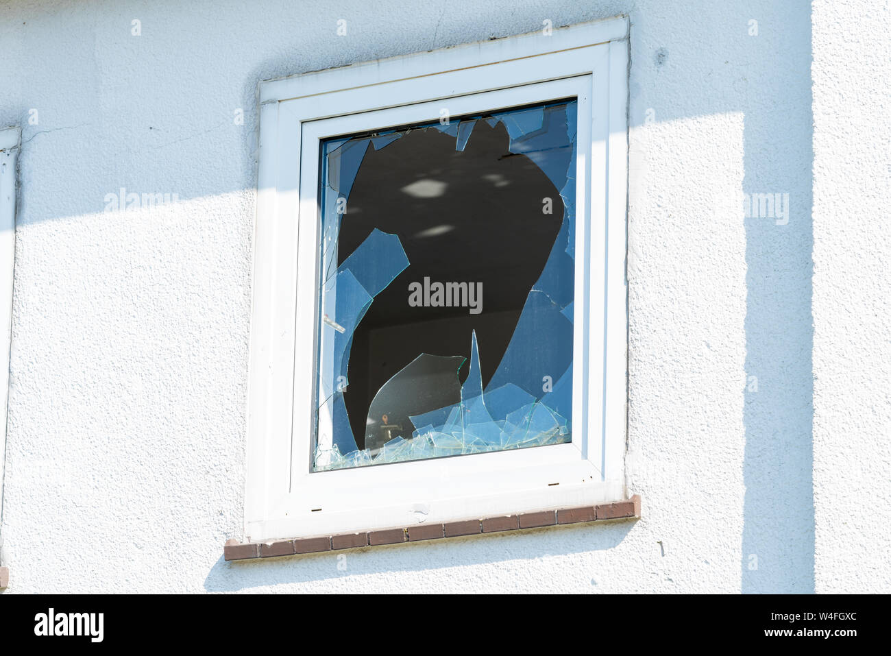 window with cracked glass after stone throw vandalism Stock Photo - Alamy