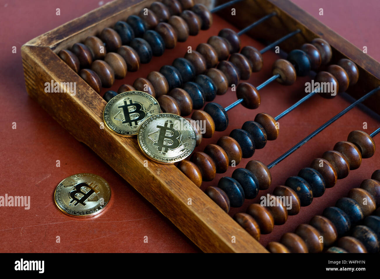Bitcoins and classic abacus and symbol of new and old financial tool ...