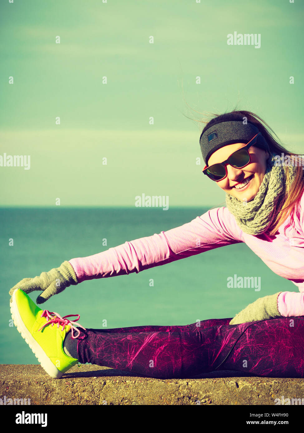 Woman athlete girl training wearing warm sporty clothes outside by ...