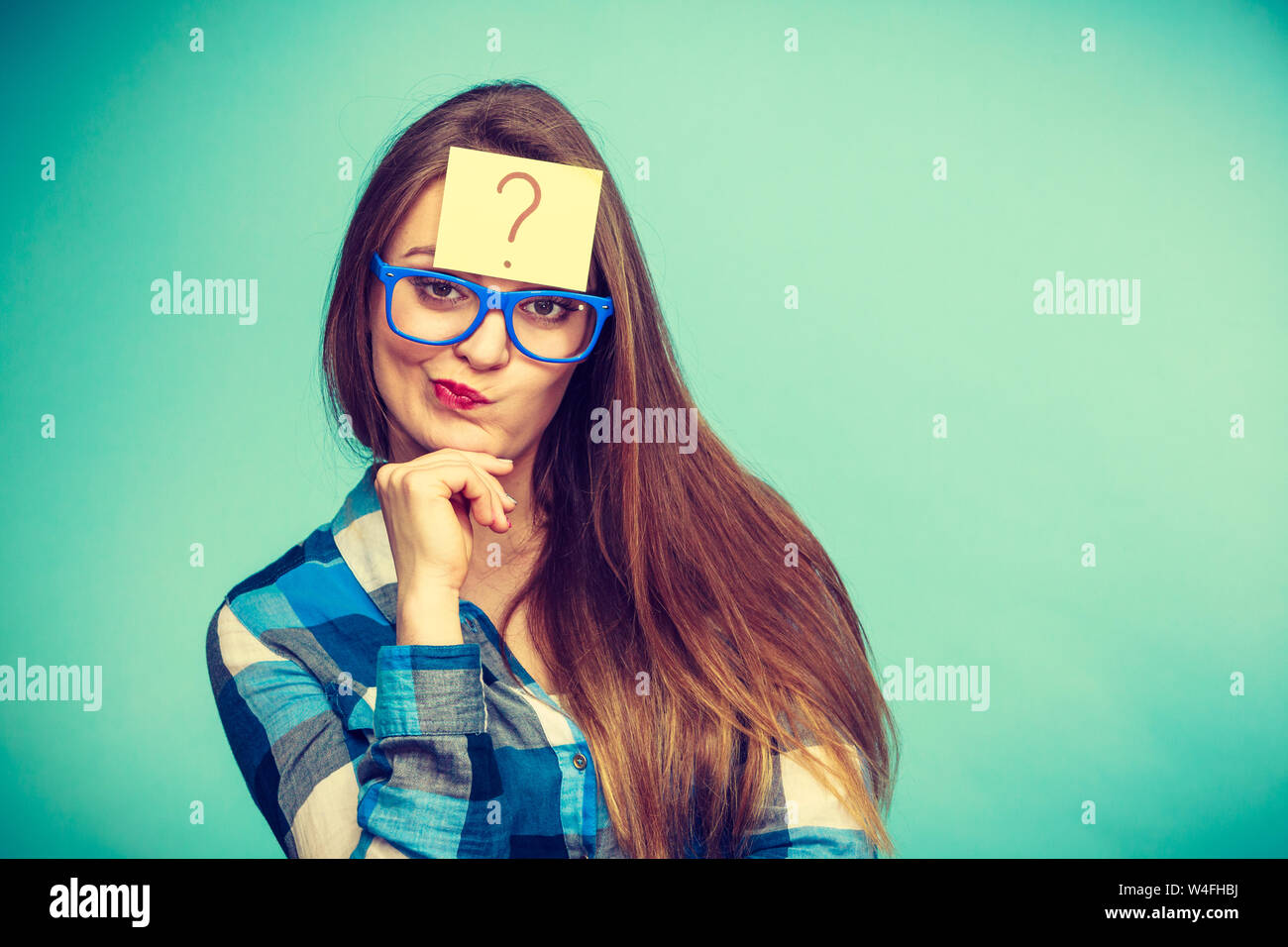 Thinking woman with big nerdy eyeglasses and question mark on forehead ...