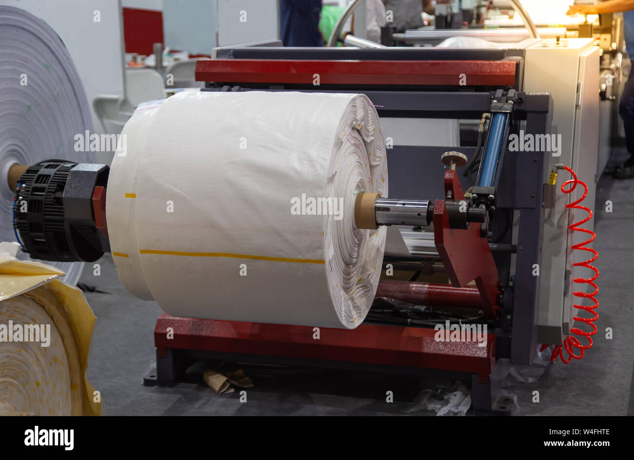 Roller of plastic sack on plastic woven machine Stock Photo - Alamy