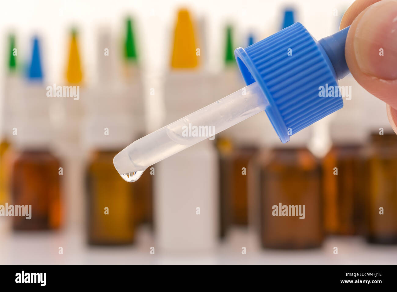 Dropper of nose drops in detail with cold sprays in the background ...