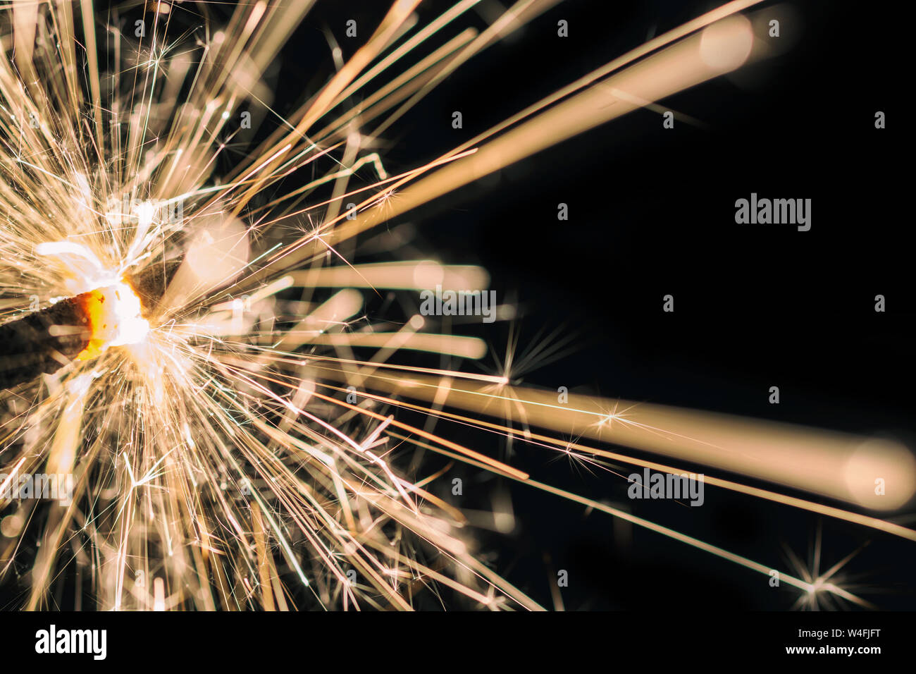 Sparkling sparkler in front of black background Stock Photo - Alamy