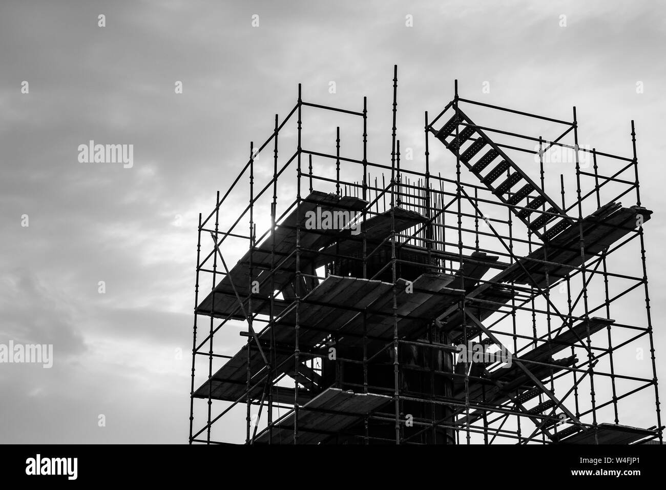 Tower is under construction, stairs and scaffolding structures, black ...