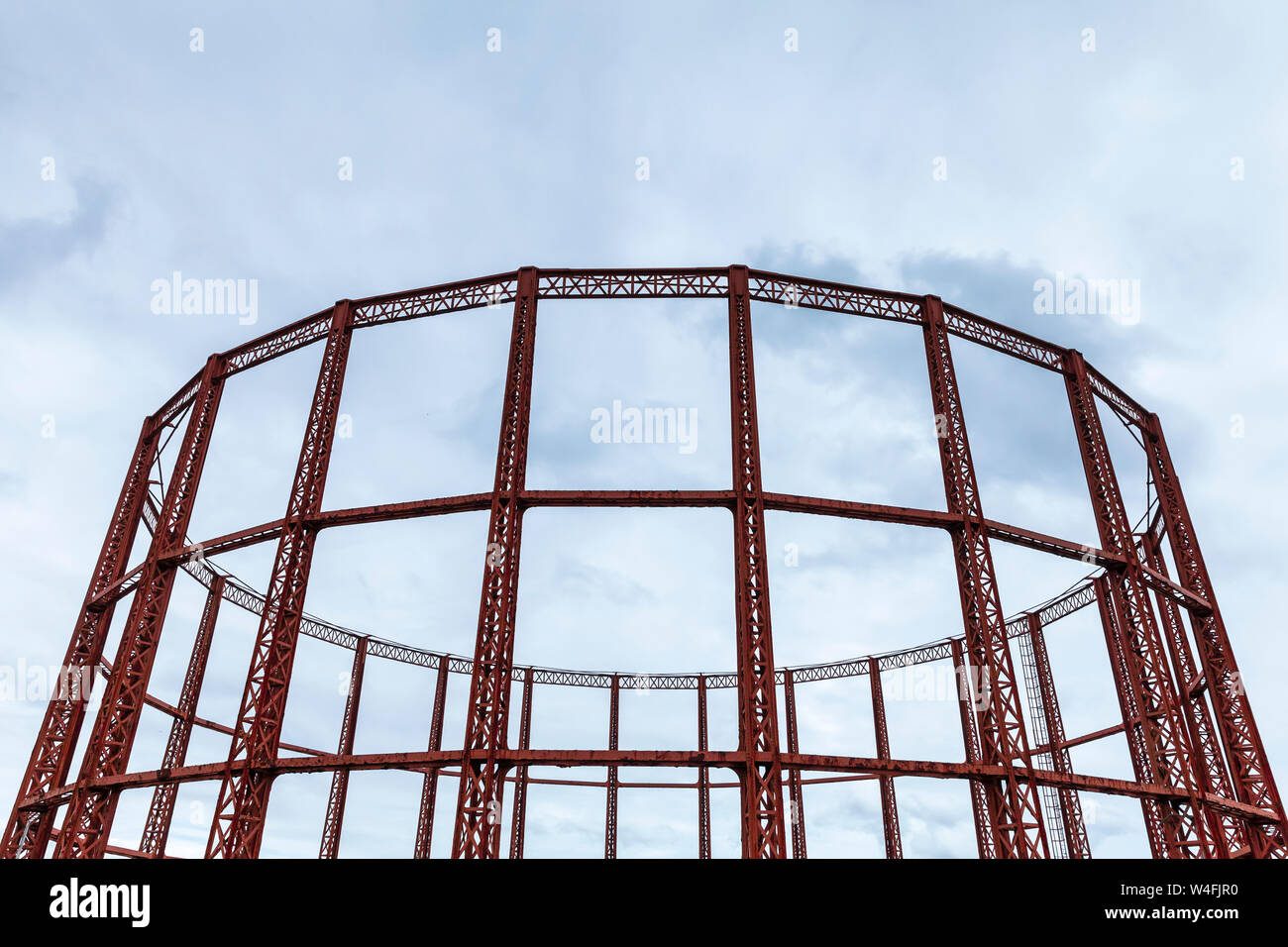 Red steel tank carcass is under blue sky, abstract industrial photo ...