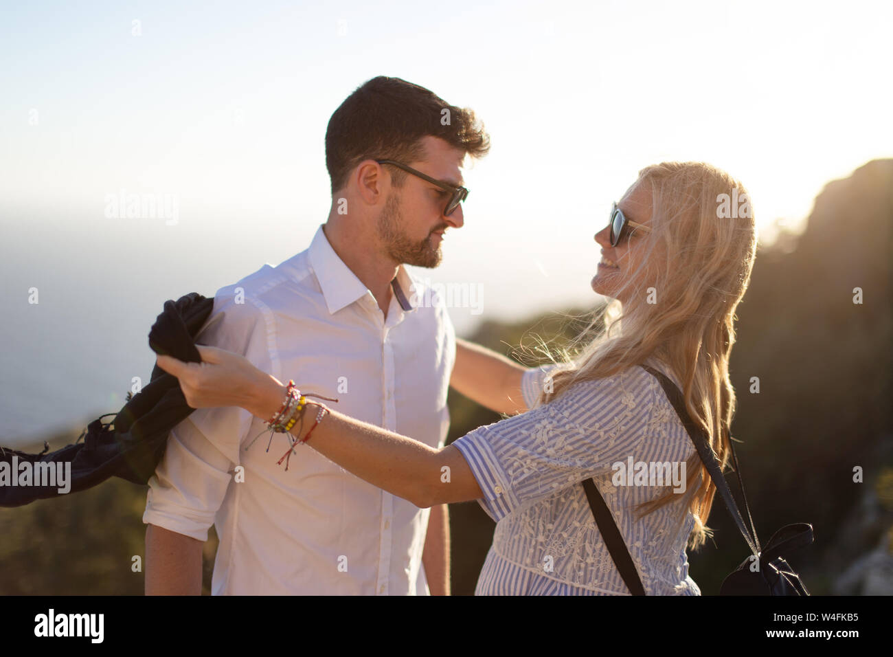Happy young couple in love smiling in sunset, enjoying moments together ...