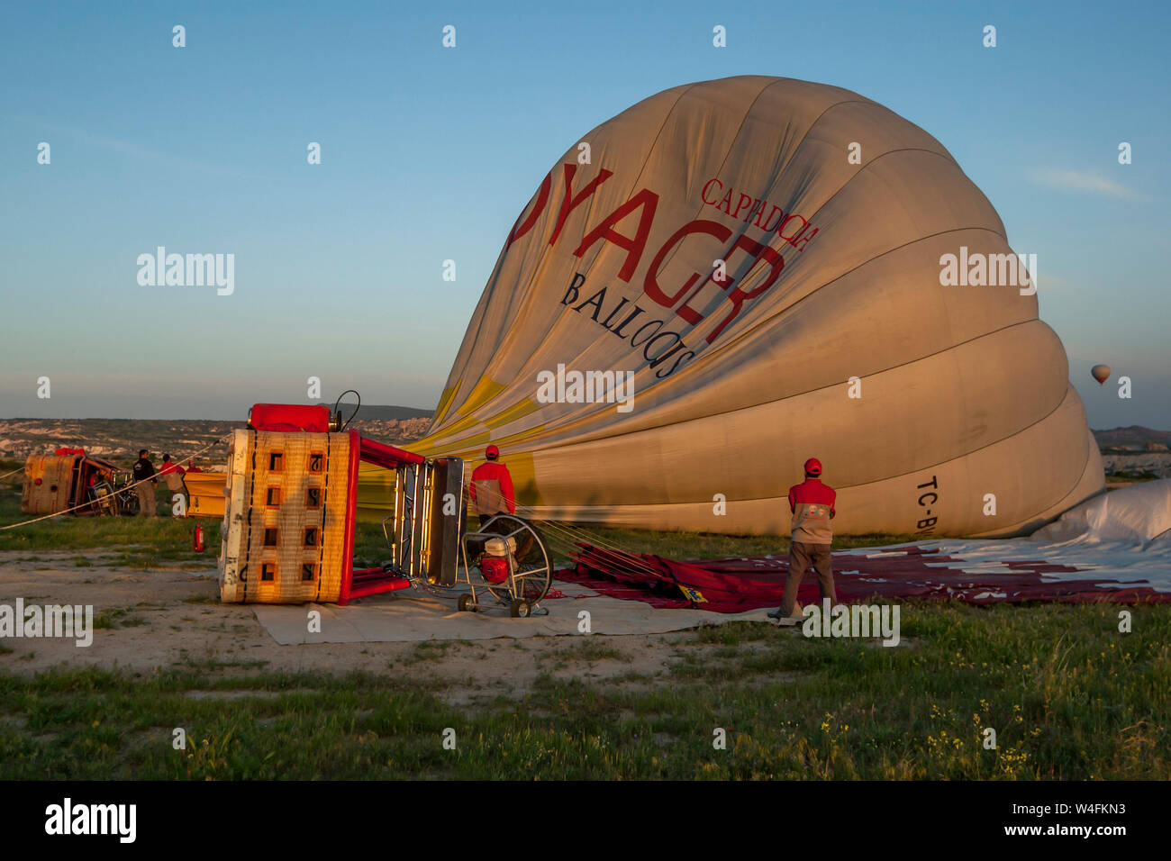 Ground staff prepare hot air balloons for take-off at Goreme in the ...