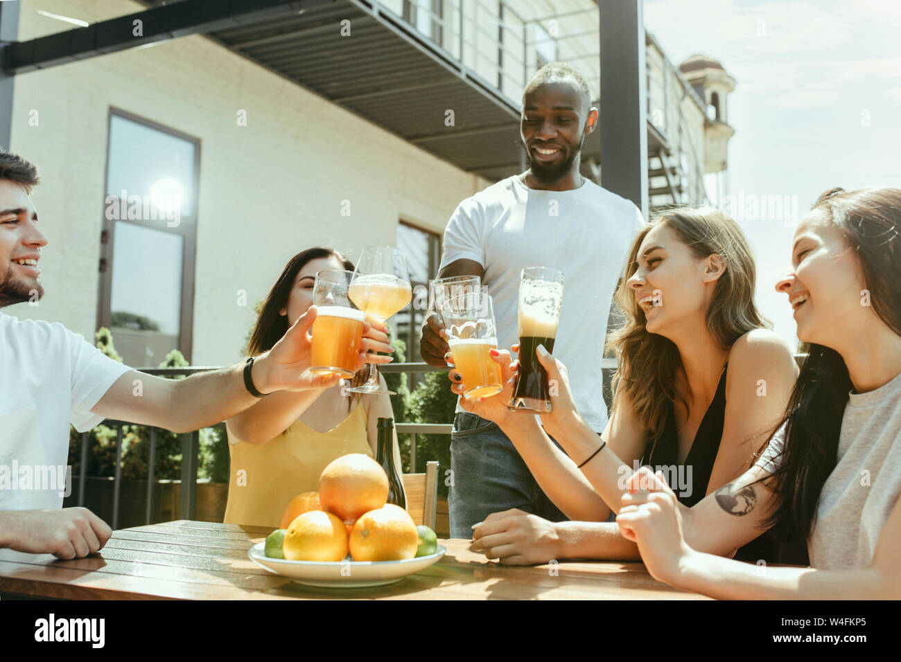 Young group of friends drinking beer, having fun, laughting and ...