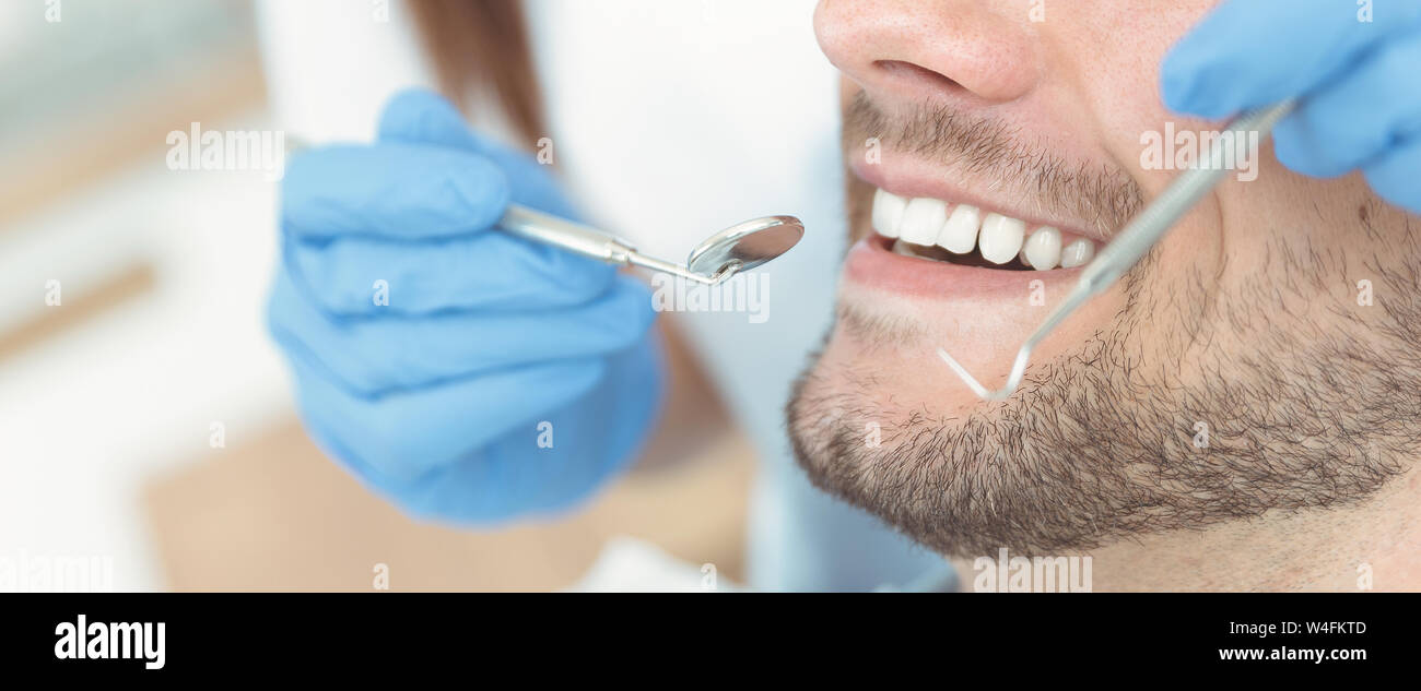 Young man at the dentist. Dental care, treatment of teeth, taking care ...