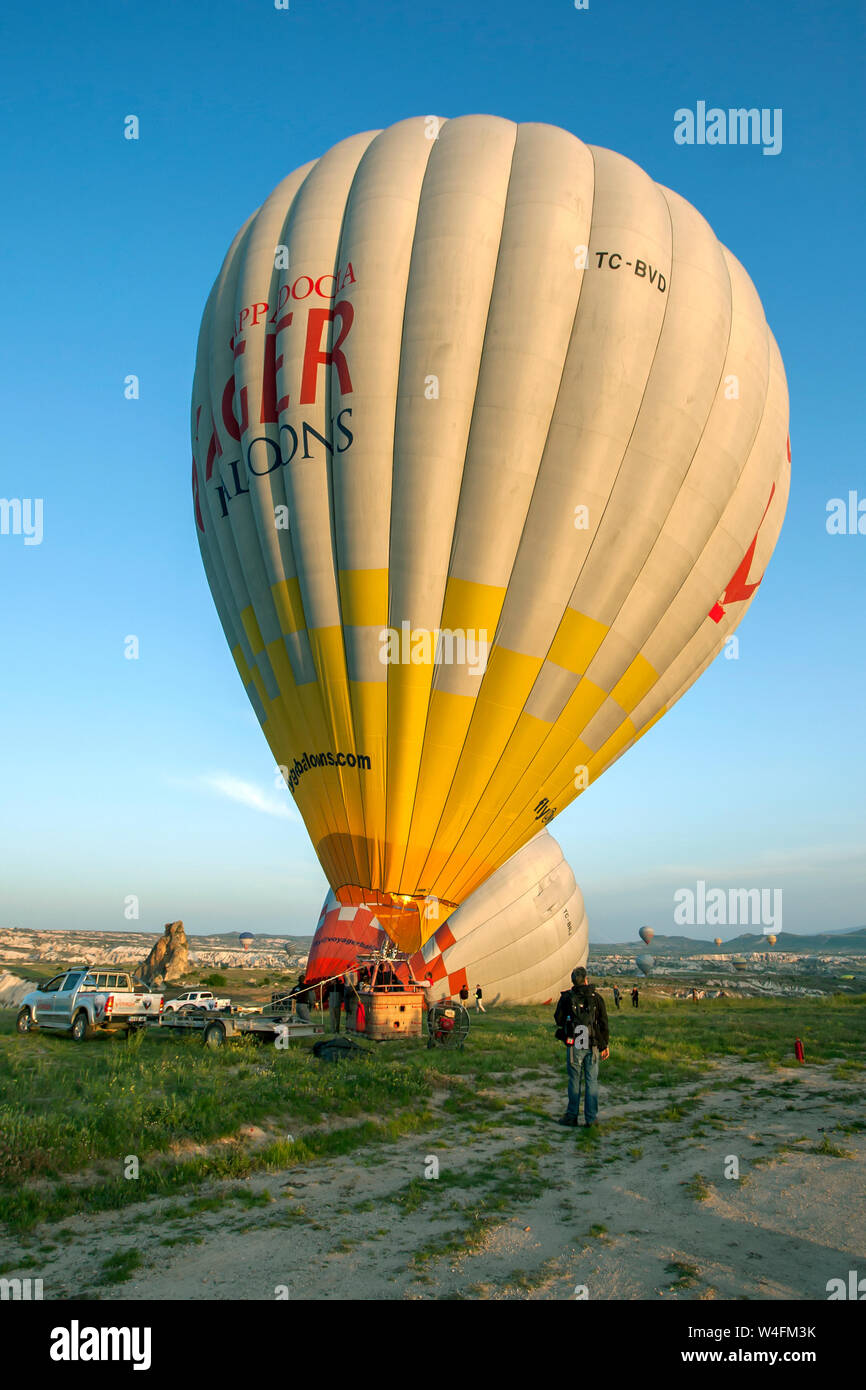 Ground staff prepare hot air balloons for take-off at Goreme in the ...