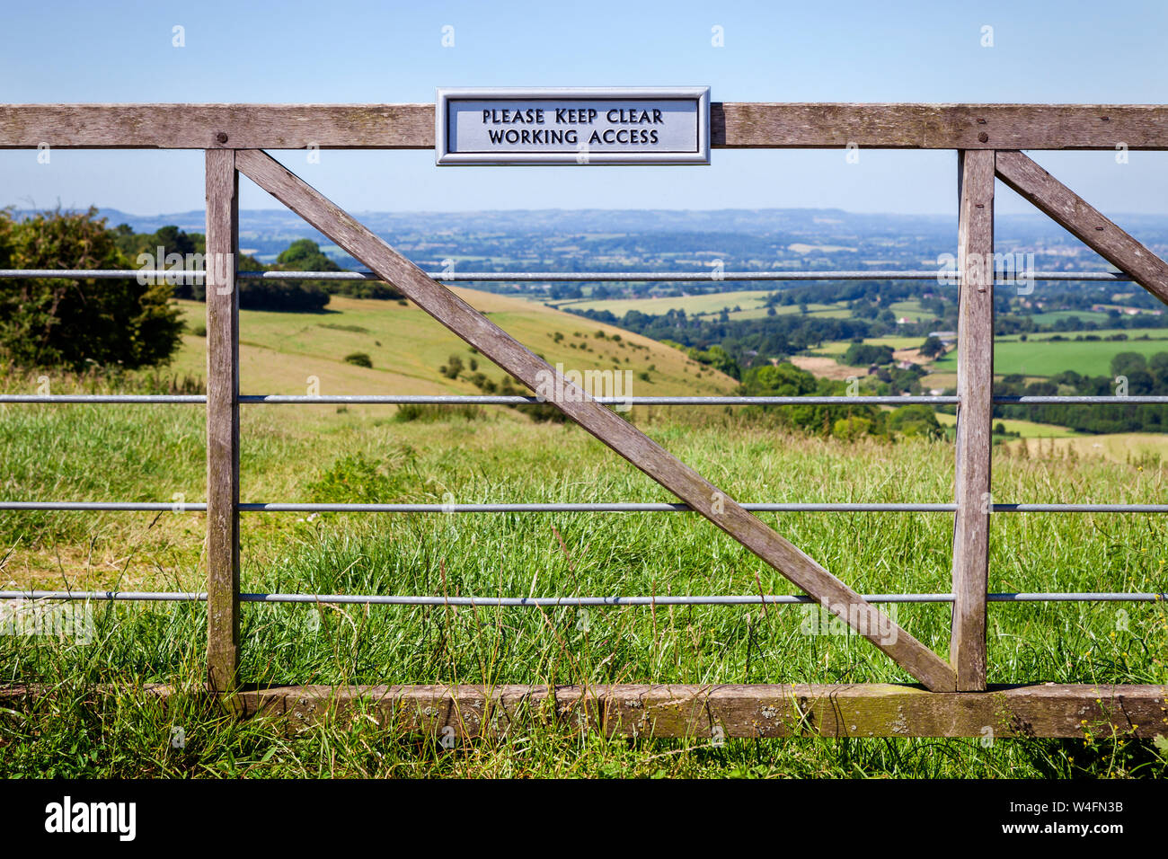 Farm gate, with sign, with the countryside behind Stock Photo - Alamy