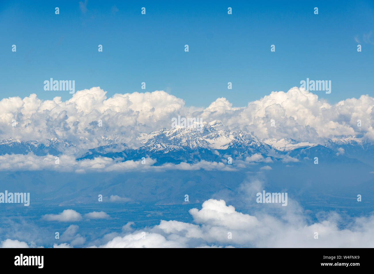 Beautiful view of surrounding mountains blending with white clouds at ...