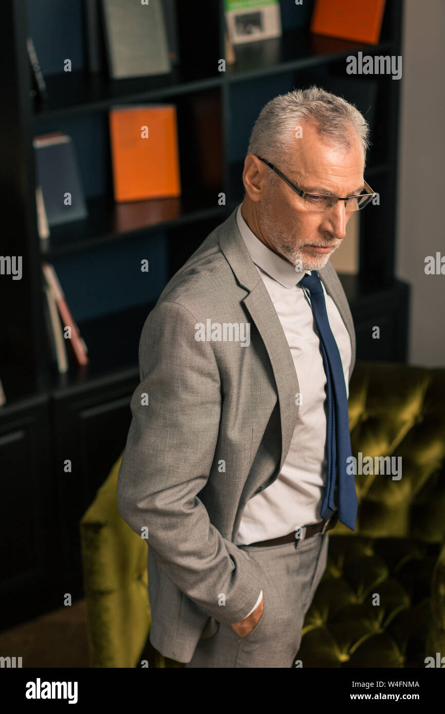 Hand in a pocket. Portrait of a thoughtful good-looking senior man ...