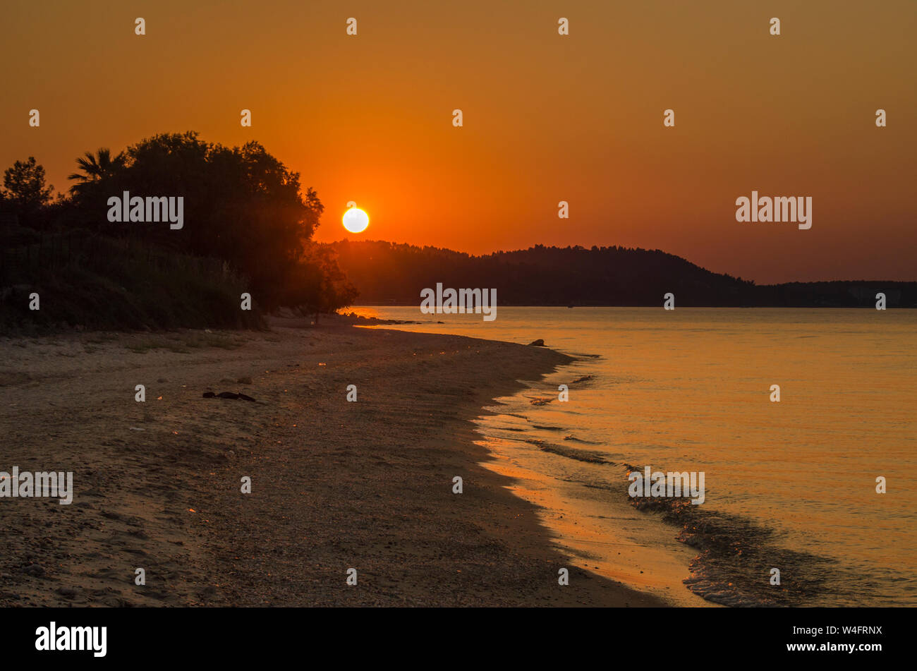 Sun rays - sunset beach scene - Aegean Coast – Greece, Polychrono Stock ...