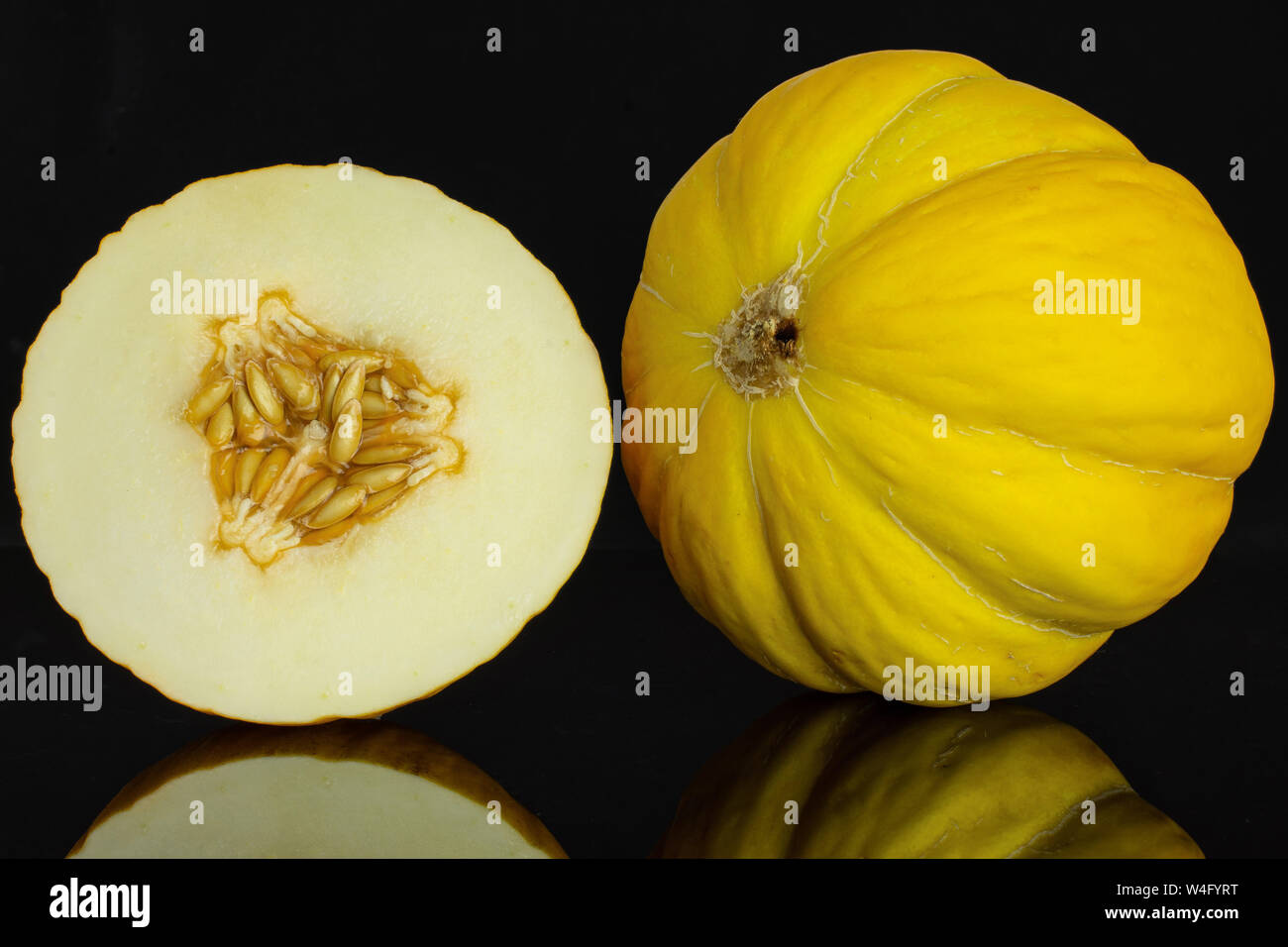 Group of one whole one half of ribbed fresh yellow melon canary cross ...