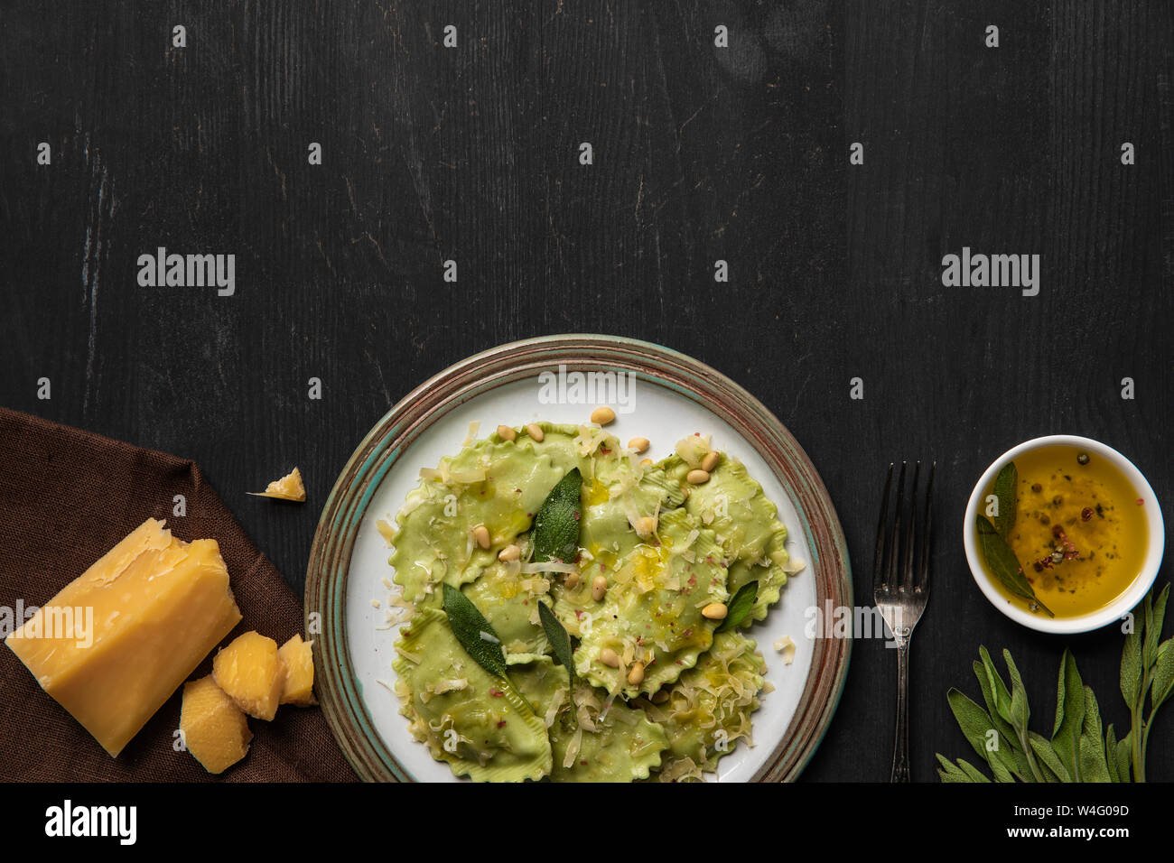 top view of green ravioli served in vintage plate near silver fork ...