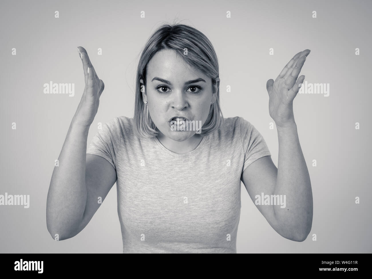 Black and white close up of young attractive caucasian woman with angry ...