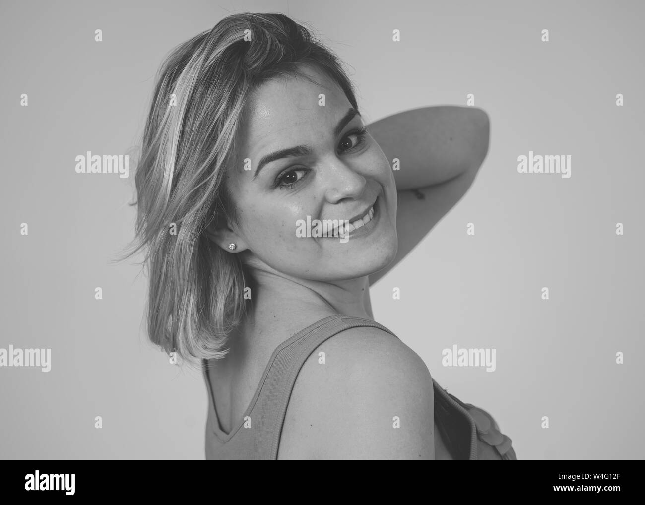 Black and white over the shoulder portrait of young pretty caucasian ...