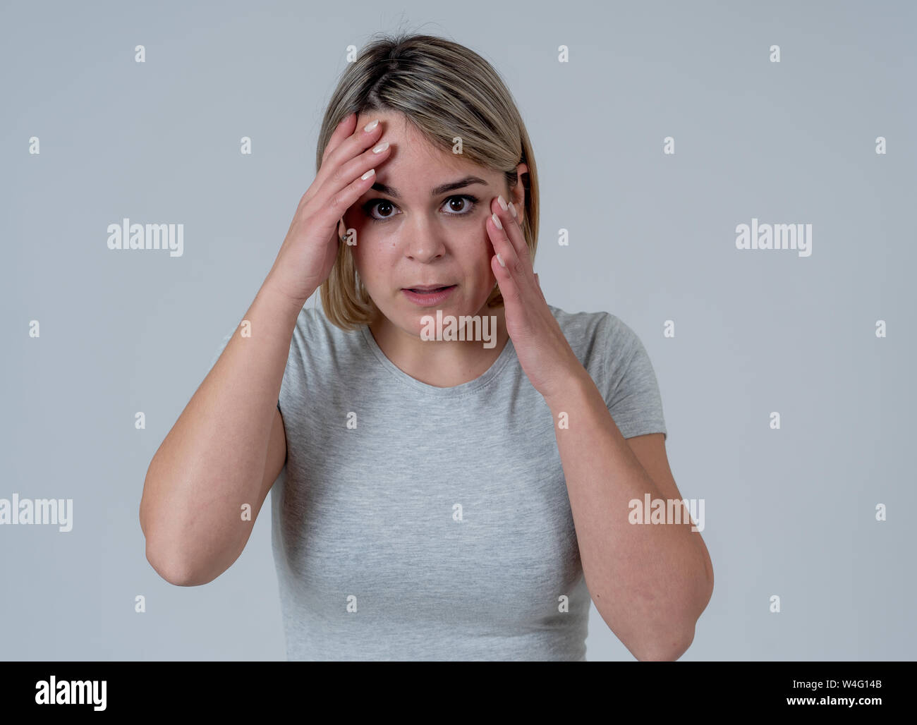 Close up portrait of young woman feeling afraid and shocked hiding her ...