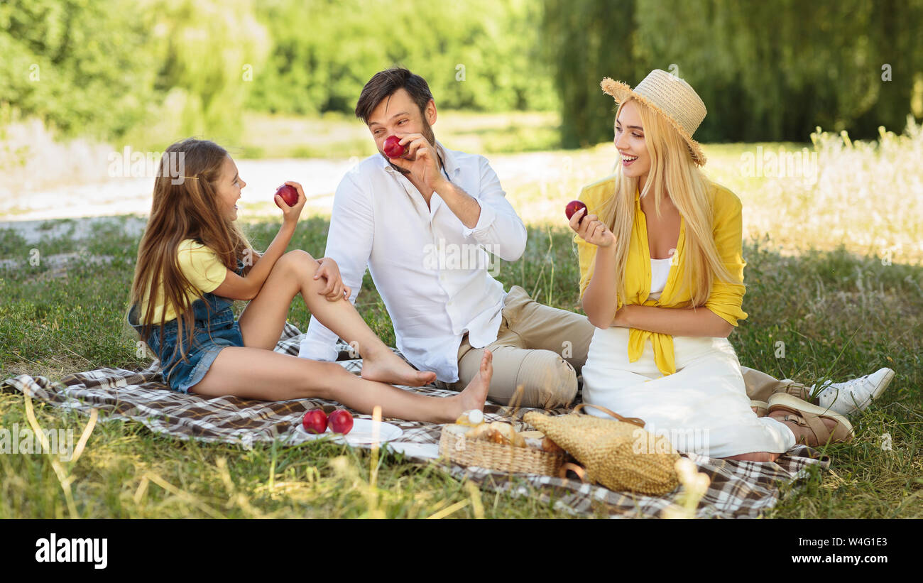 Young family having picnic in countryside on grass Stock Photo - Alamy