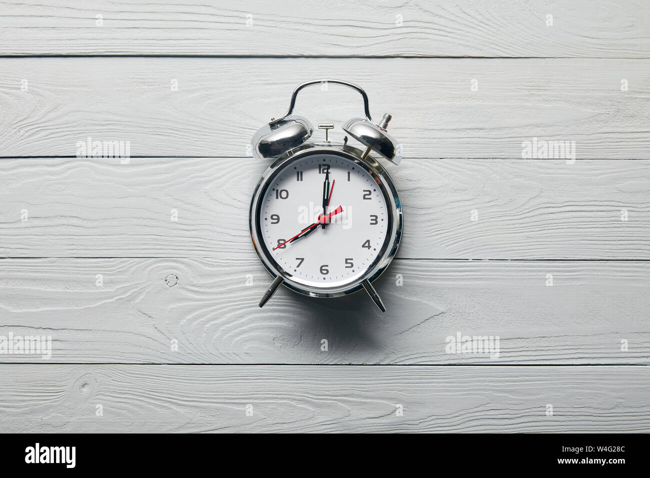 top view of silver alarm clock on wooden white background Stock Photo ...