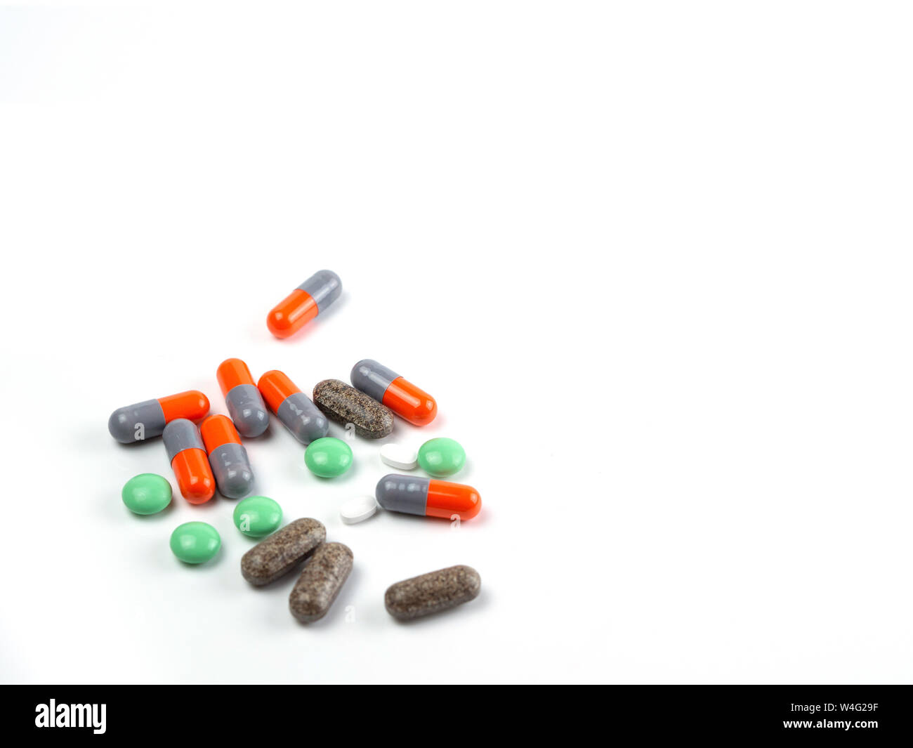 green pills and orange capsules isolated white background, Medicines ...