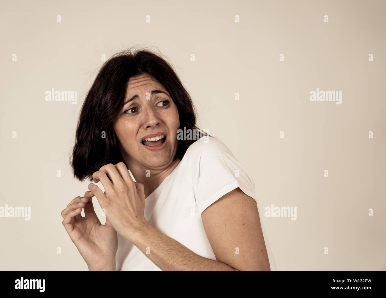 Close up of young woman with frightened eyes, shocked, cowered ...