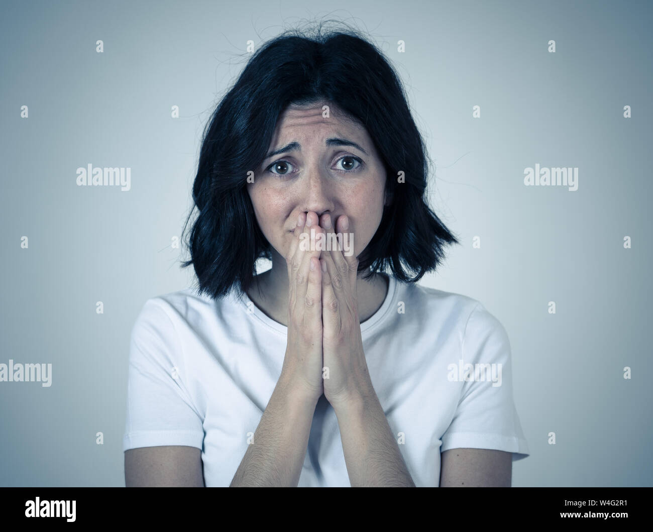 Close up of latin woman with frightened eyes, shocked making fear ...