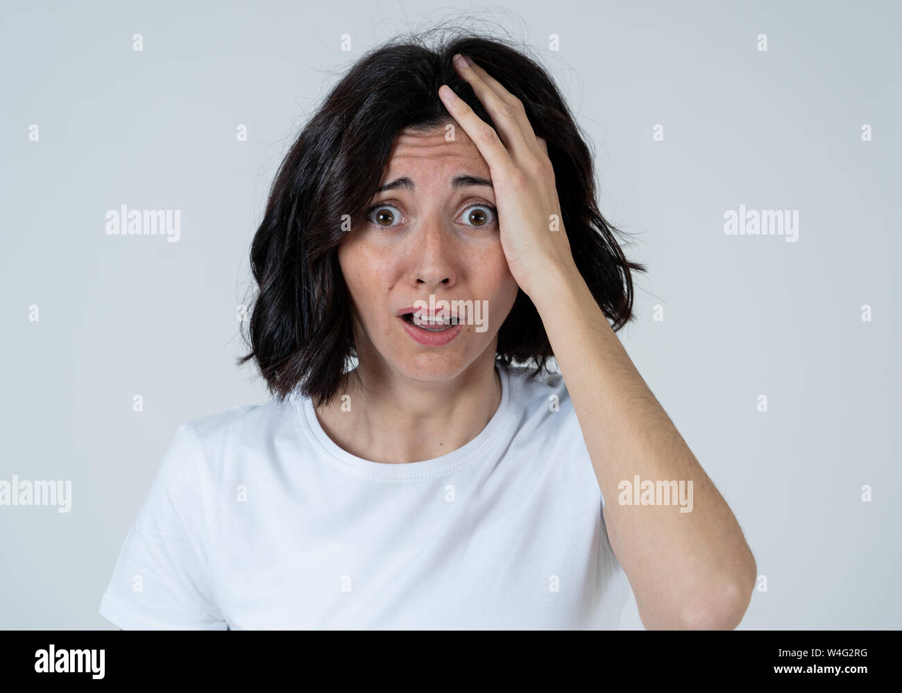 Close up of latin woman with frightened eyes, shocked making fear ...