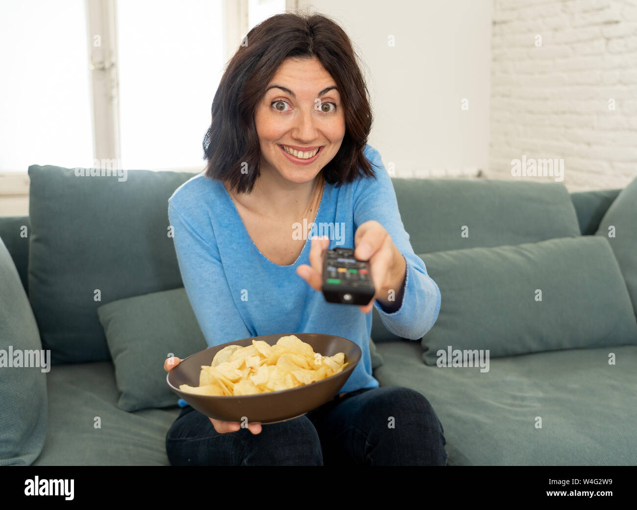 Pretty female sofa remote control hi-res stock photography and images ...