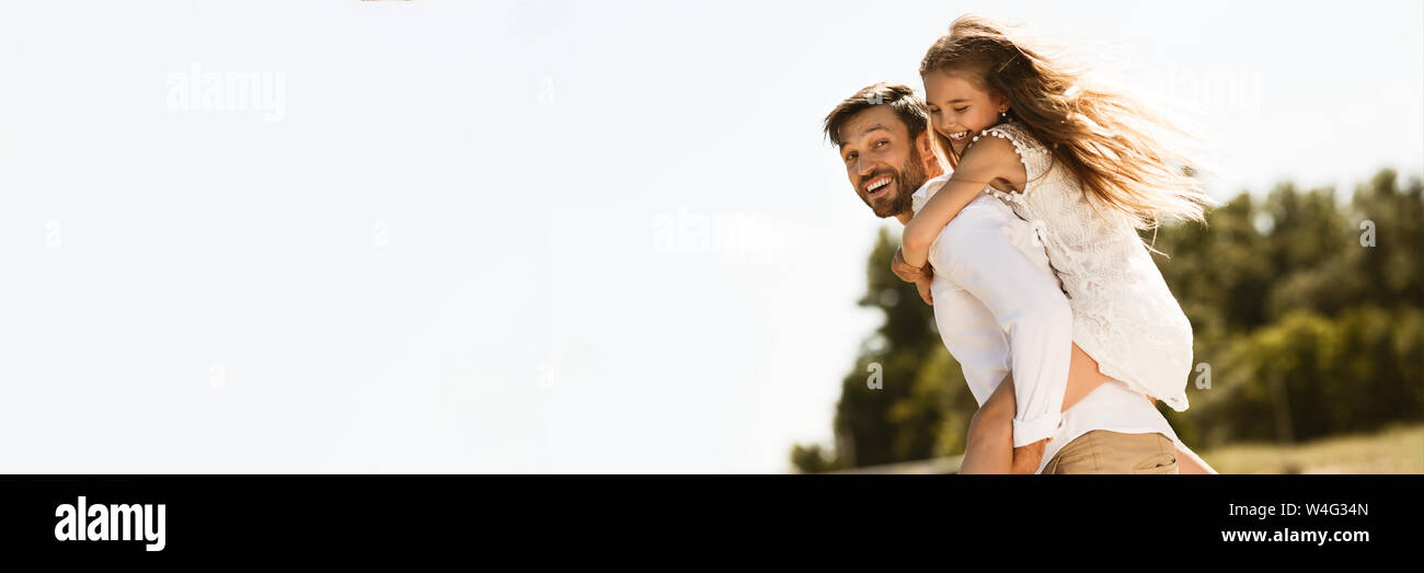 Young father carrying his daughter on back Stock Photo - Alamy