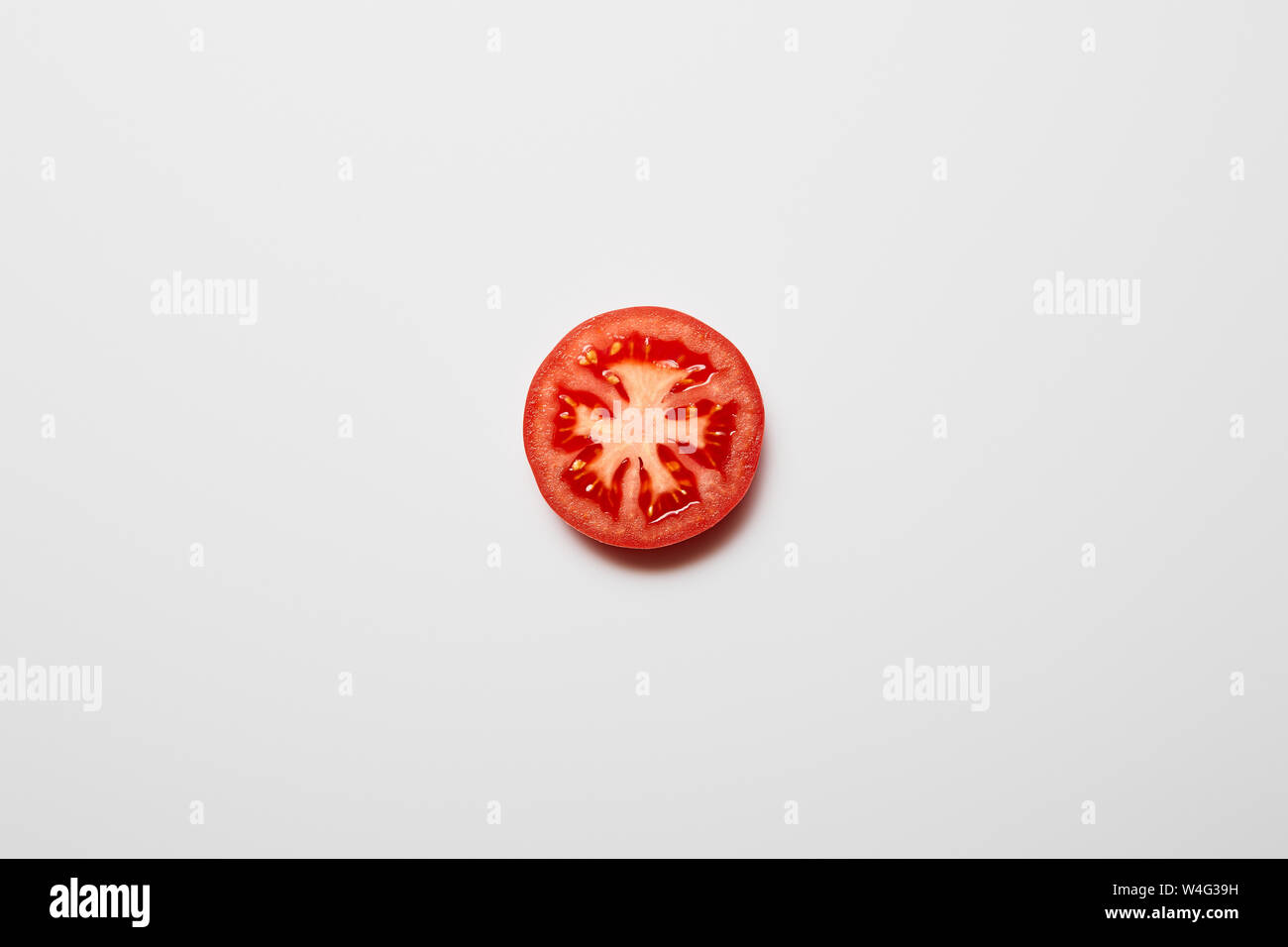 top view of fresh tomato slice on white background Stock Photo - Alamy